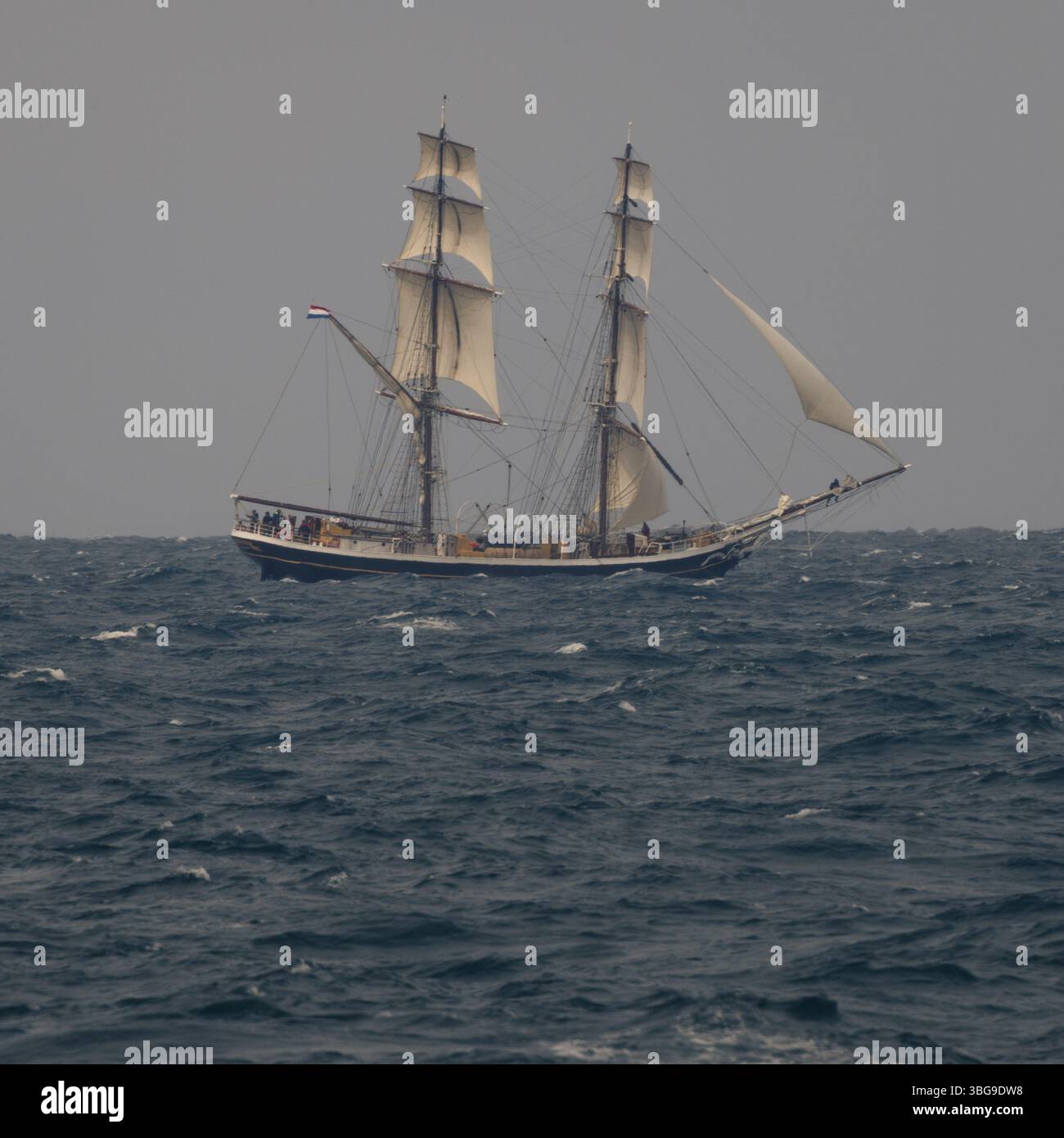 Traditional Dutch tall ship under partial sail navigating the choppy ...