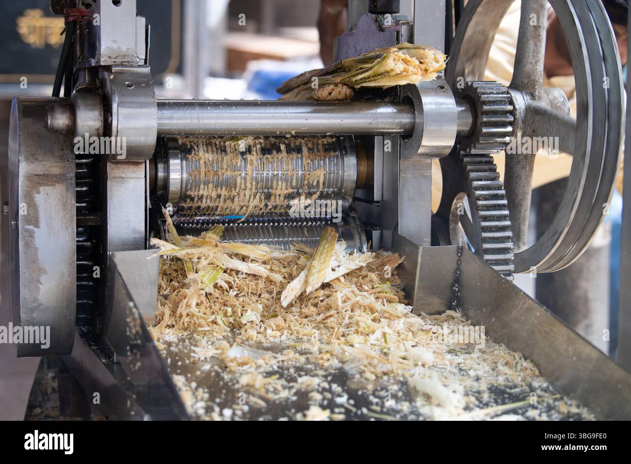 Sugarcane juicing machine on a market stall in India, fresh pressed ...