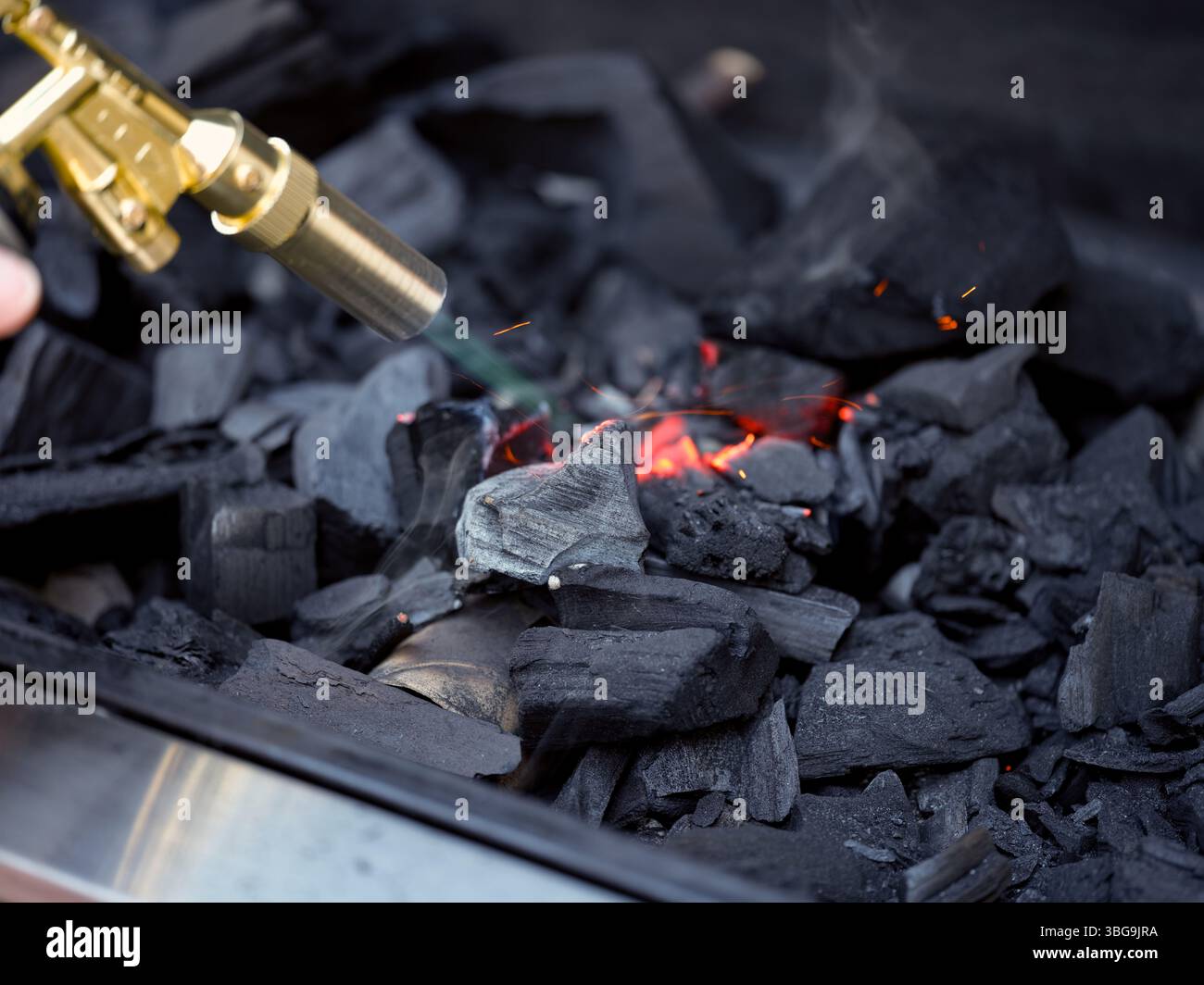 Blowtorch using to light charcoal in a BBQ grill Stock Photo - Alamy