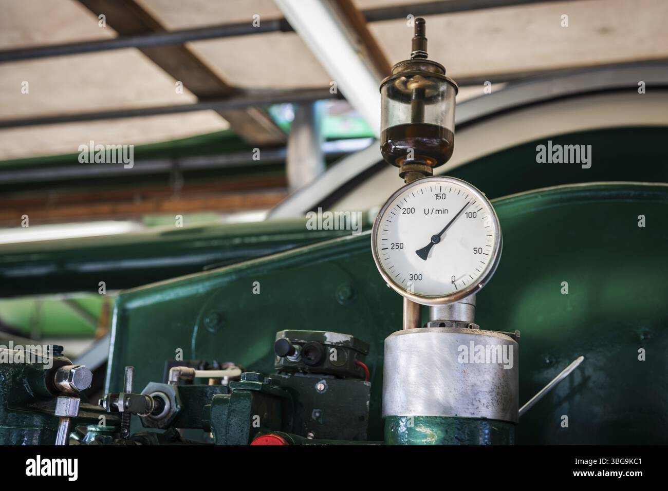 Tachometer with oil droplets mounted next to it on an old restored ...