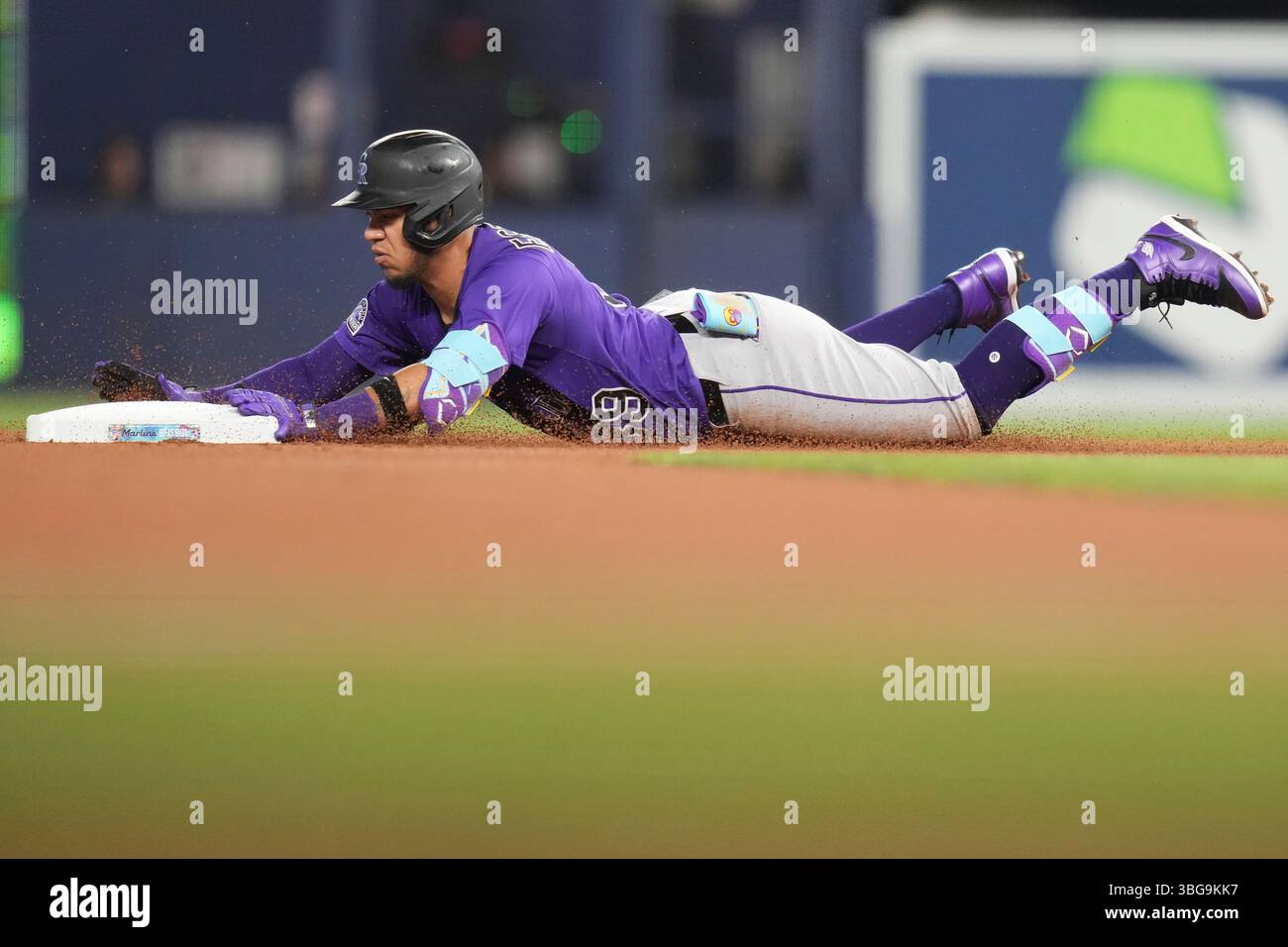 Colorado Rockies' Thairo Estrada slides into second after hitting a ...