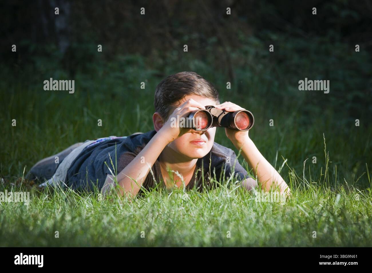 Half-lateral full-body view of a 13-year-old male teenager lying on his ...