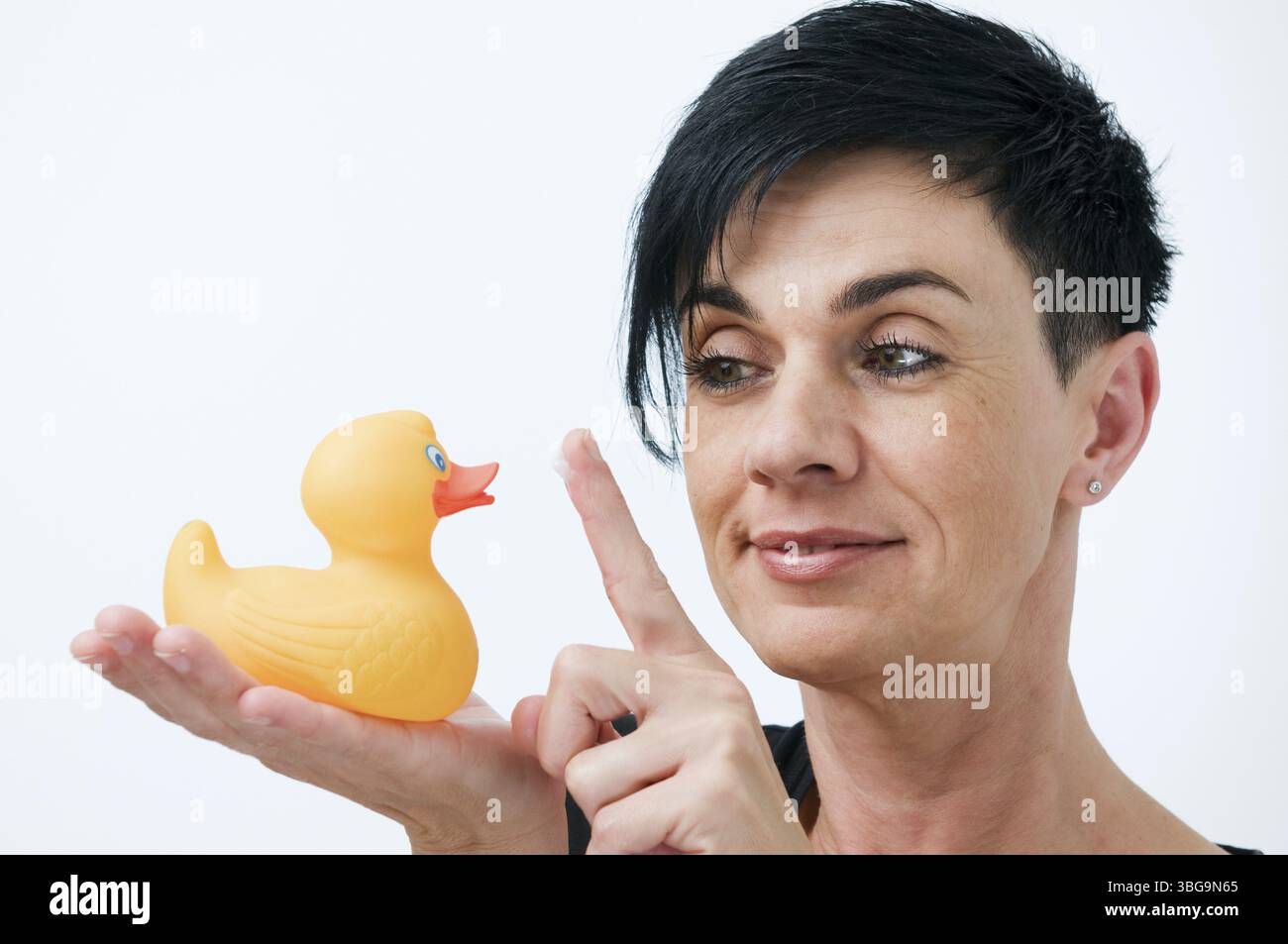 Head-and-shoulders view of a middle-aged woman with black hair, holding ...
