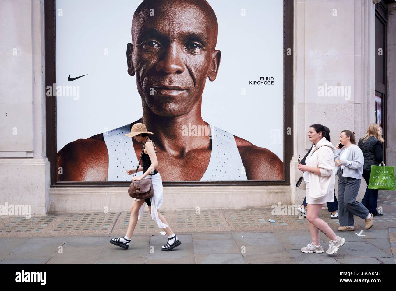 Shoppers walk past a large billboard at the Nike store on Oxford Circus ...