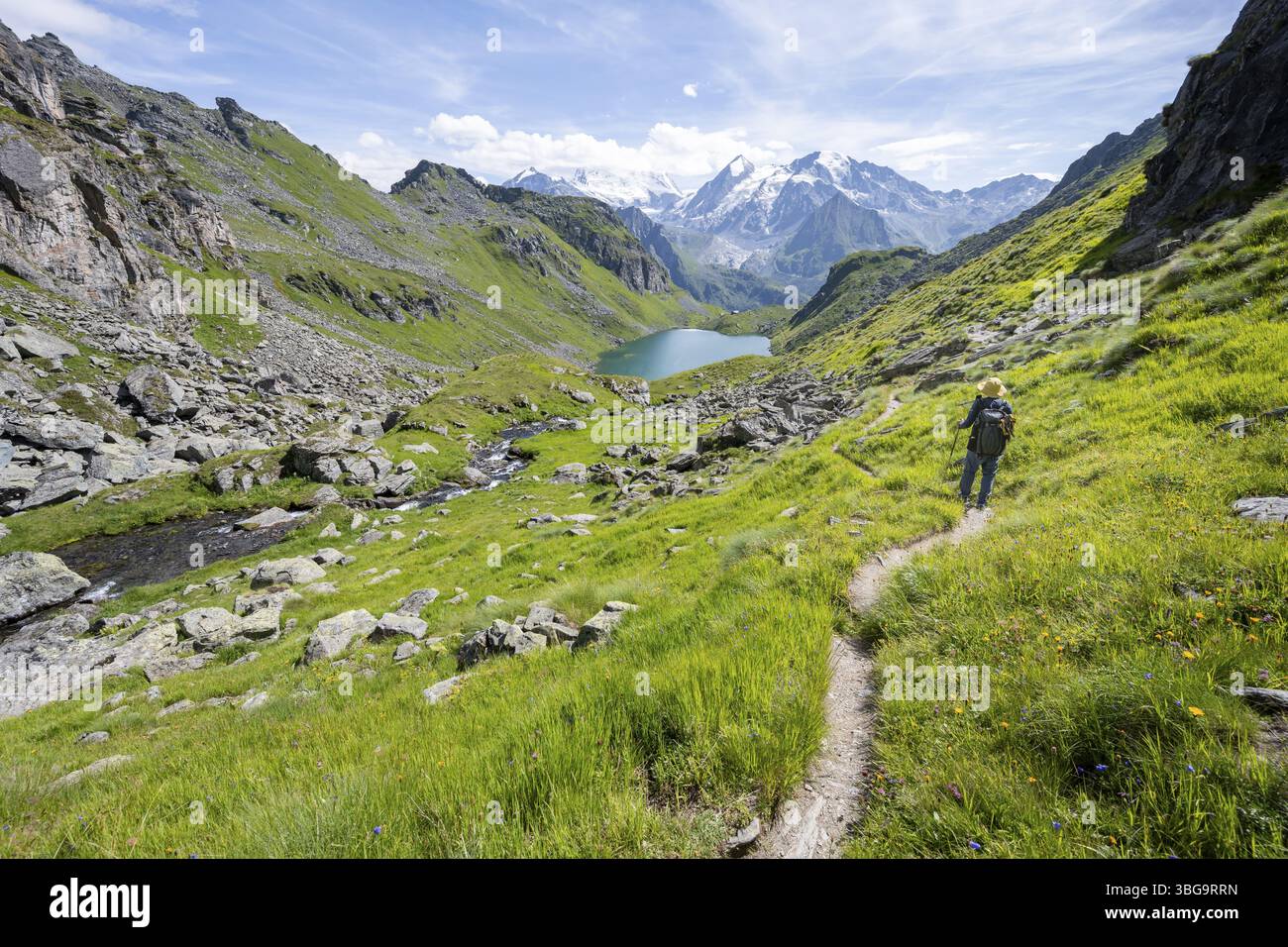 Mountaineer on hiking trail in picturesque mountain landscape, view of ...