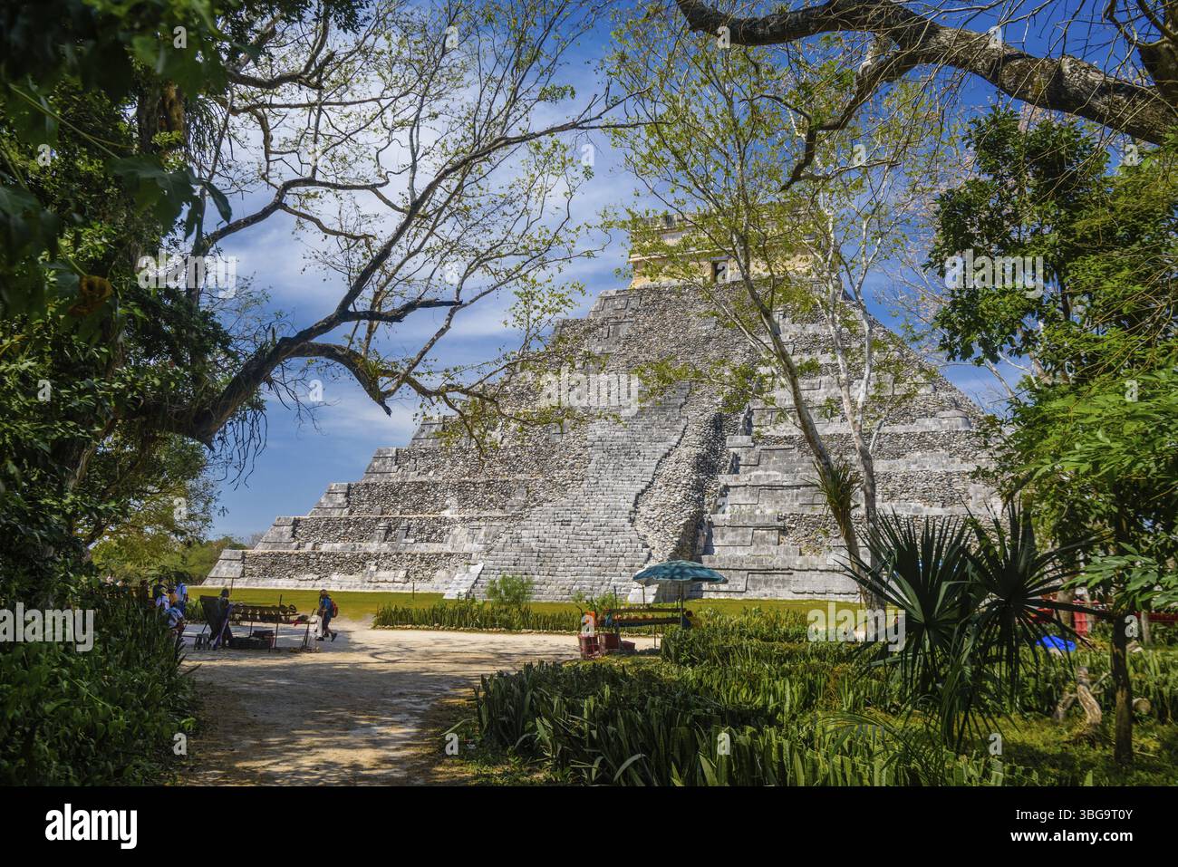 Temple pyramid of Kukulcan El Castillo behind the trees, Chichen Itza ...