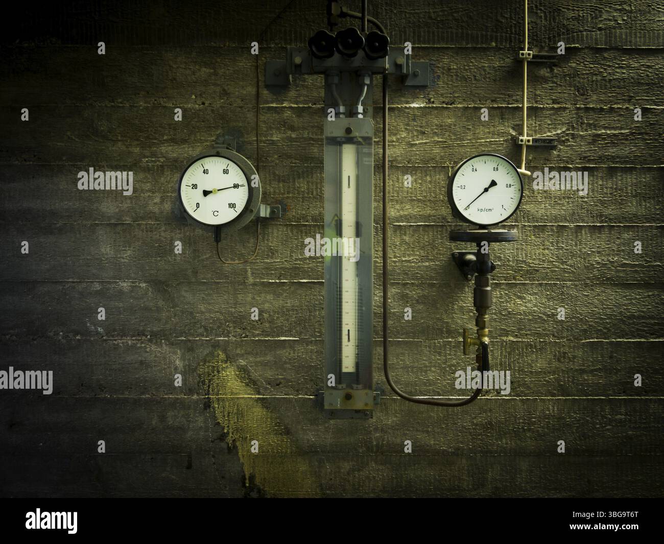 Three old analogue indicators on a concrete wall, temperature indicator ...