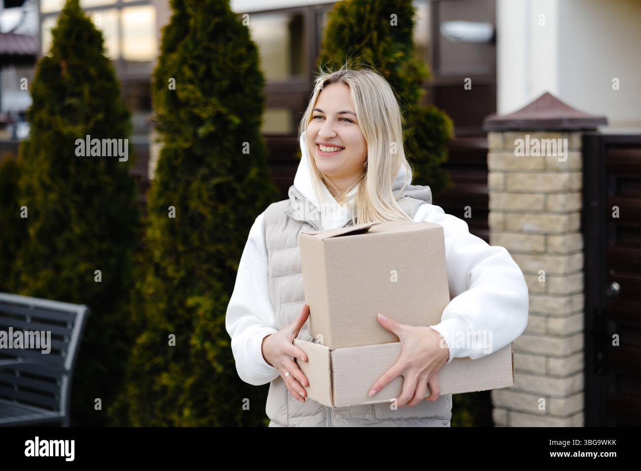 Woman delivering packages residential home hi-res stock photography and ...