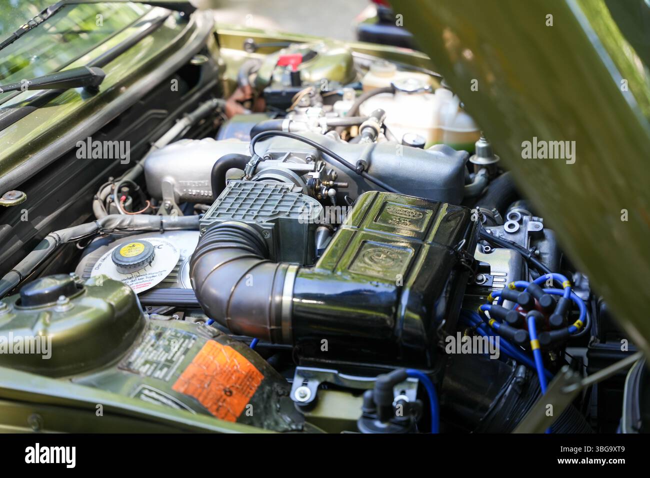 Germany Berlin May 11, 2025. Classic car engine compartment with green ...