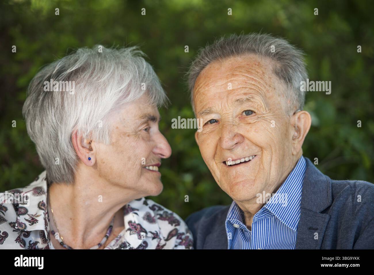 Head-and-shoulder portrait of an 80 year old pensioner couple against ...