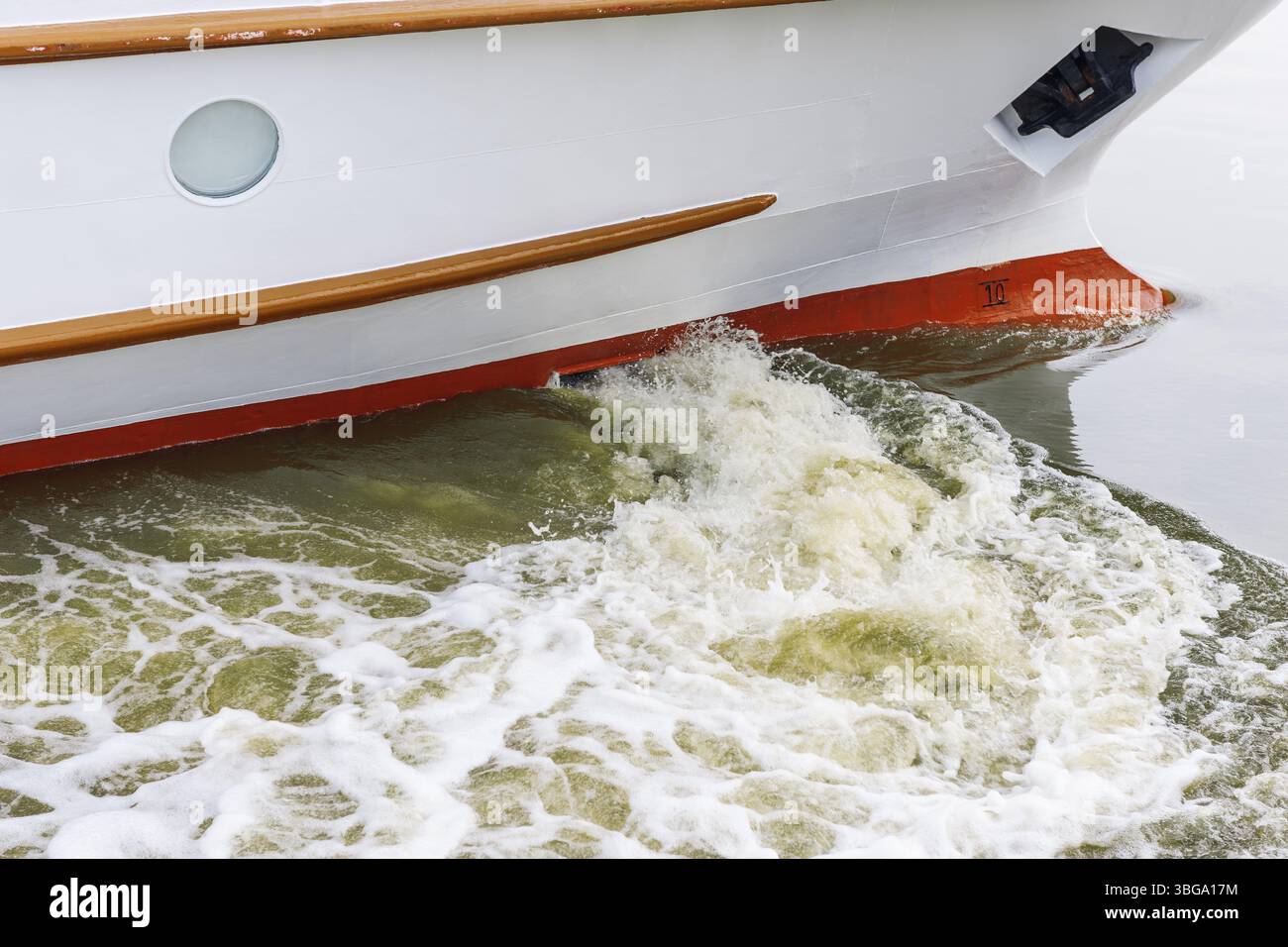 Front part of a white passenger ship with anchor and porthole during a ...