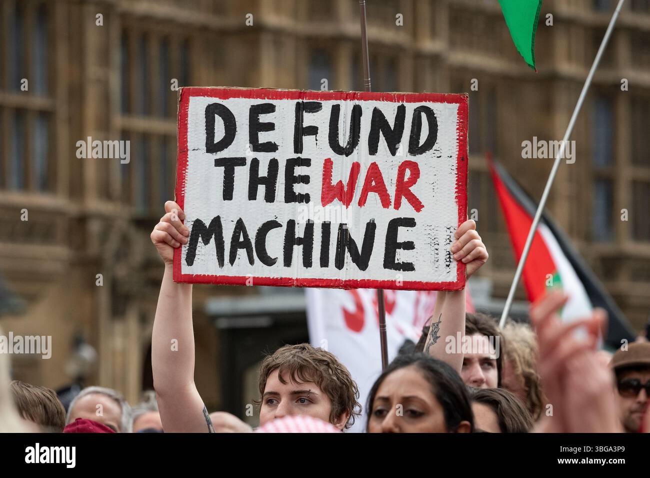 London, UK. 4 June, 2025. A protester holds a placard reading "Defund ...