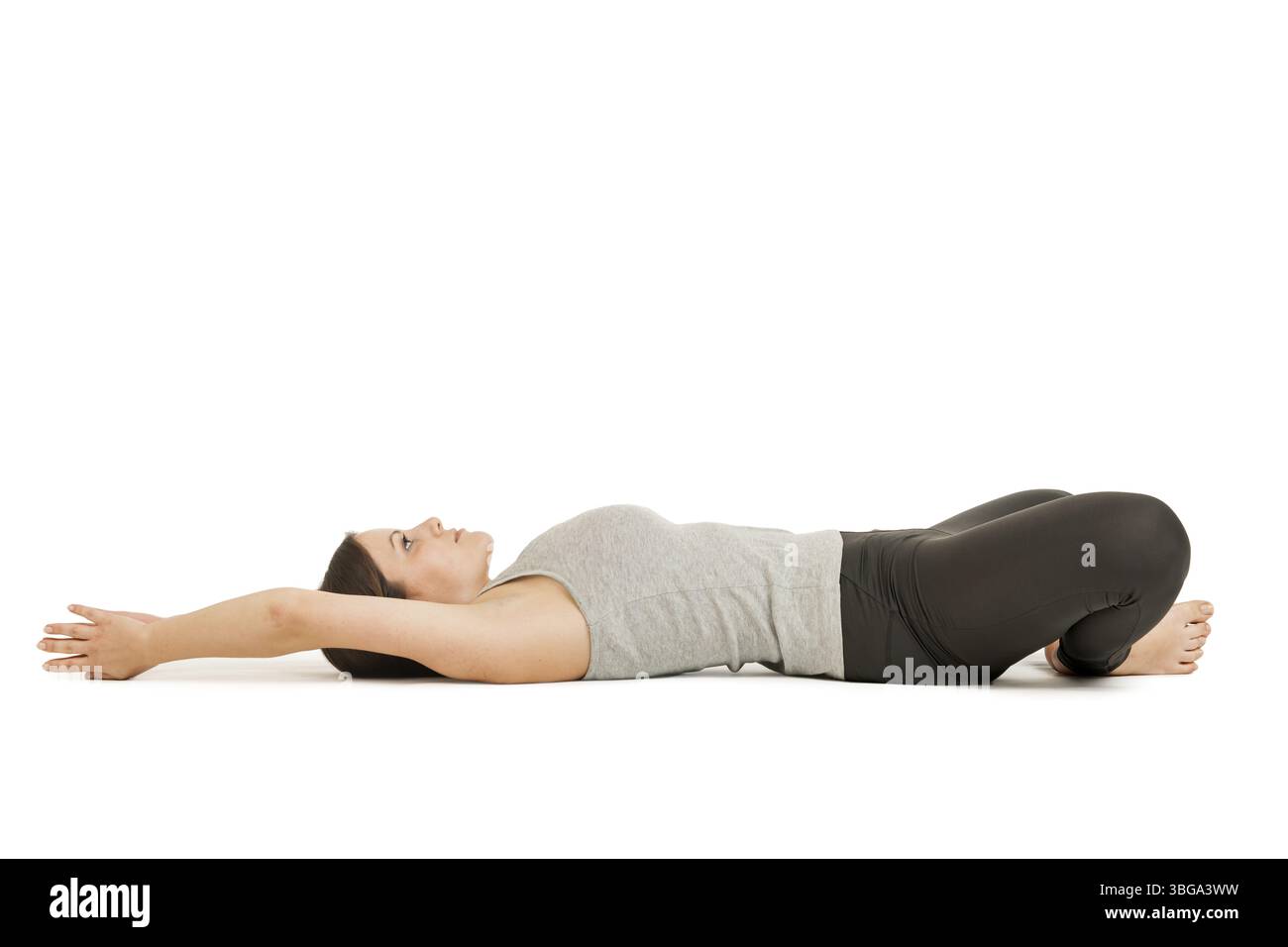 Side profile full body view of a young woman lying on her back in the ...