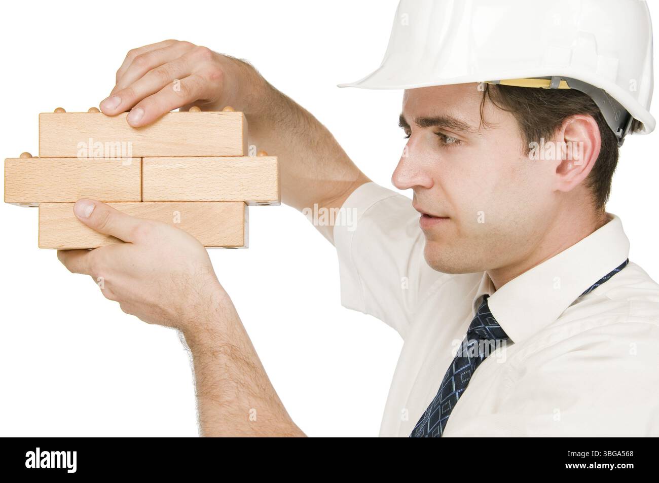 Lateral upper body shot of a young man in a white shirt and white ...