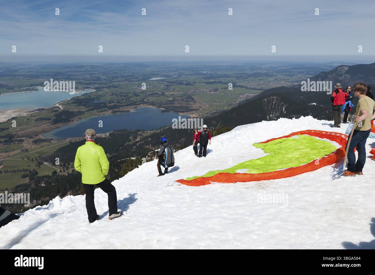 Wide-angle side view of a paraglider in take-off position at the launch ...
