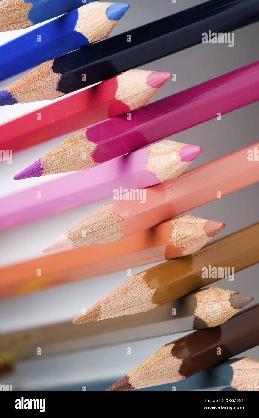 Close-up oblique view of crayons stacked crosswise in the colours of ...