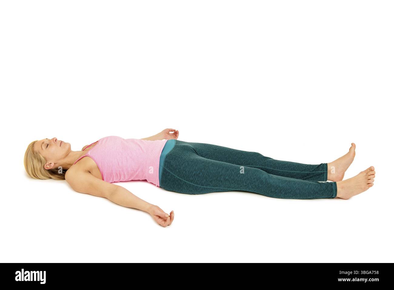Flat-angled full-body side view of a young woman lying on her back in ...