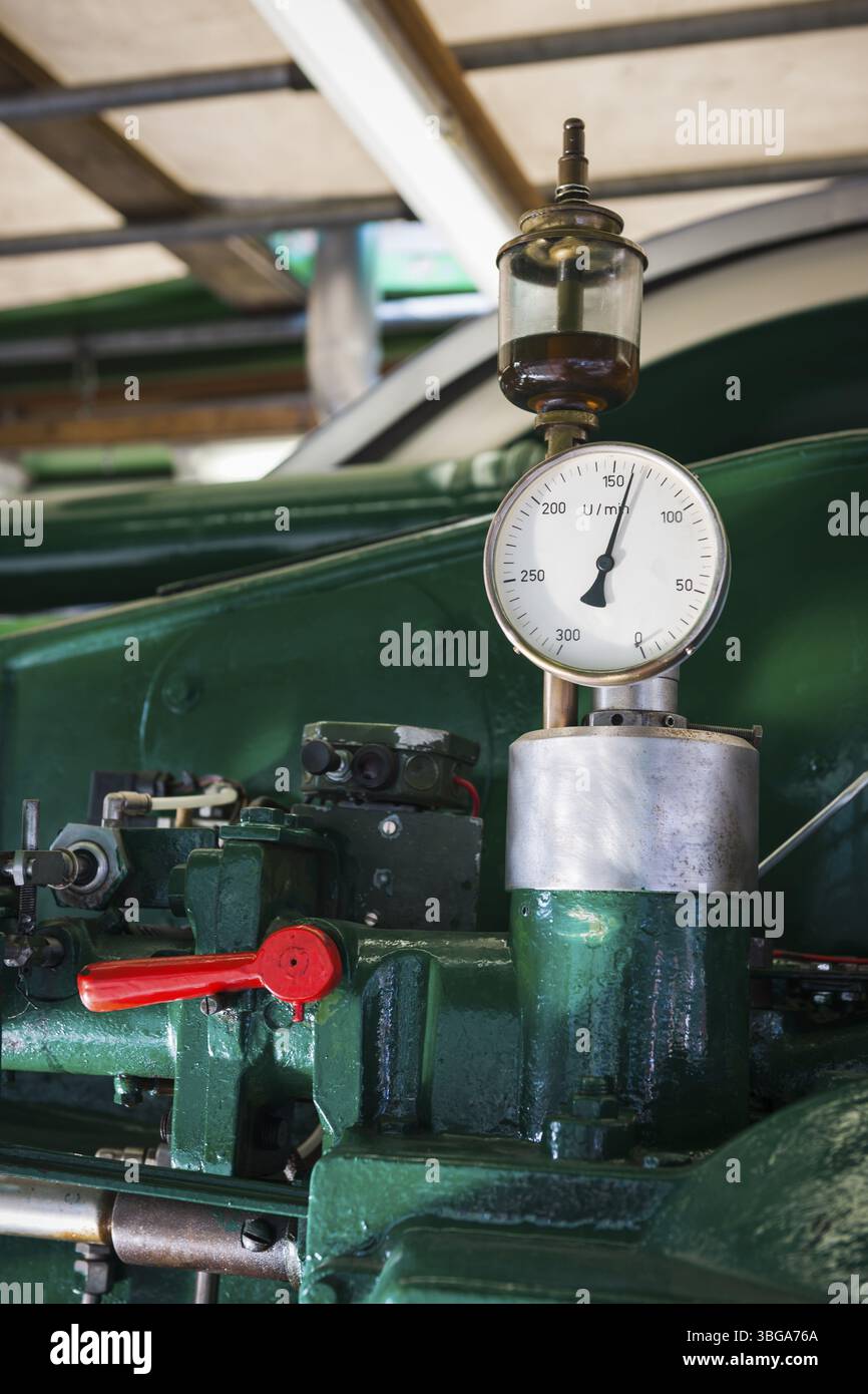 Tachometer with oil droplets mounted next to it on an old restored ...