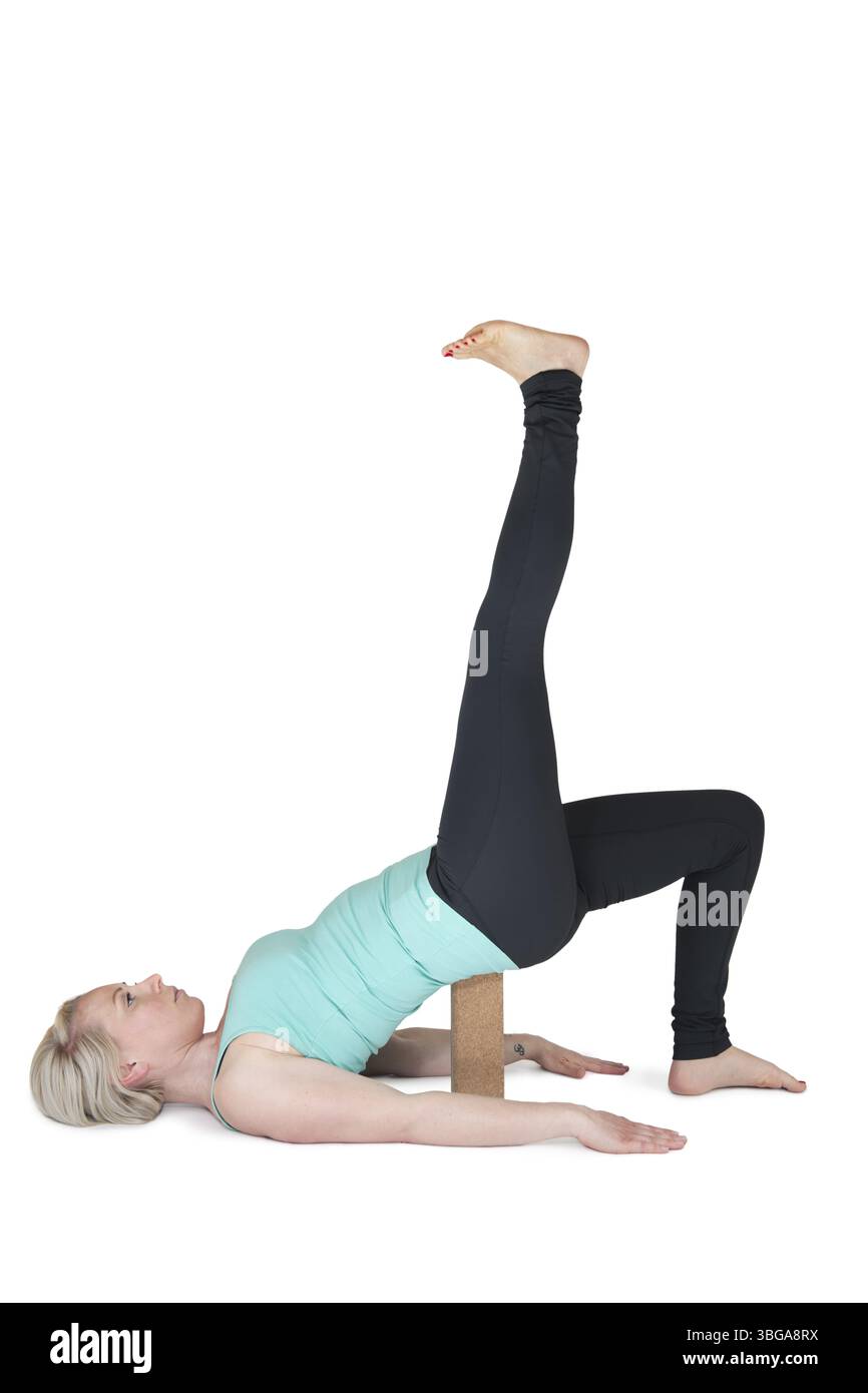 Young woman on the back lying on bowed legs and one leg stretched ...