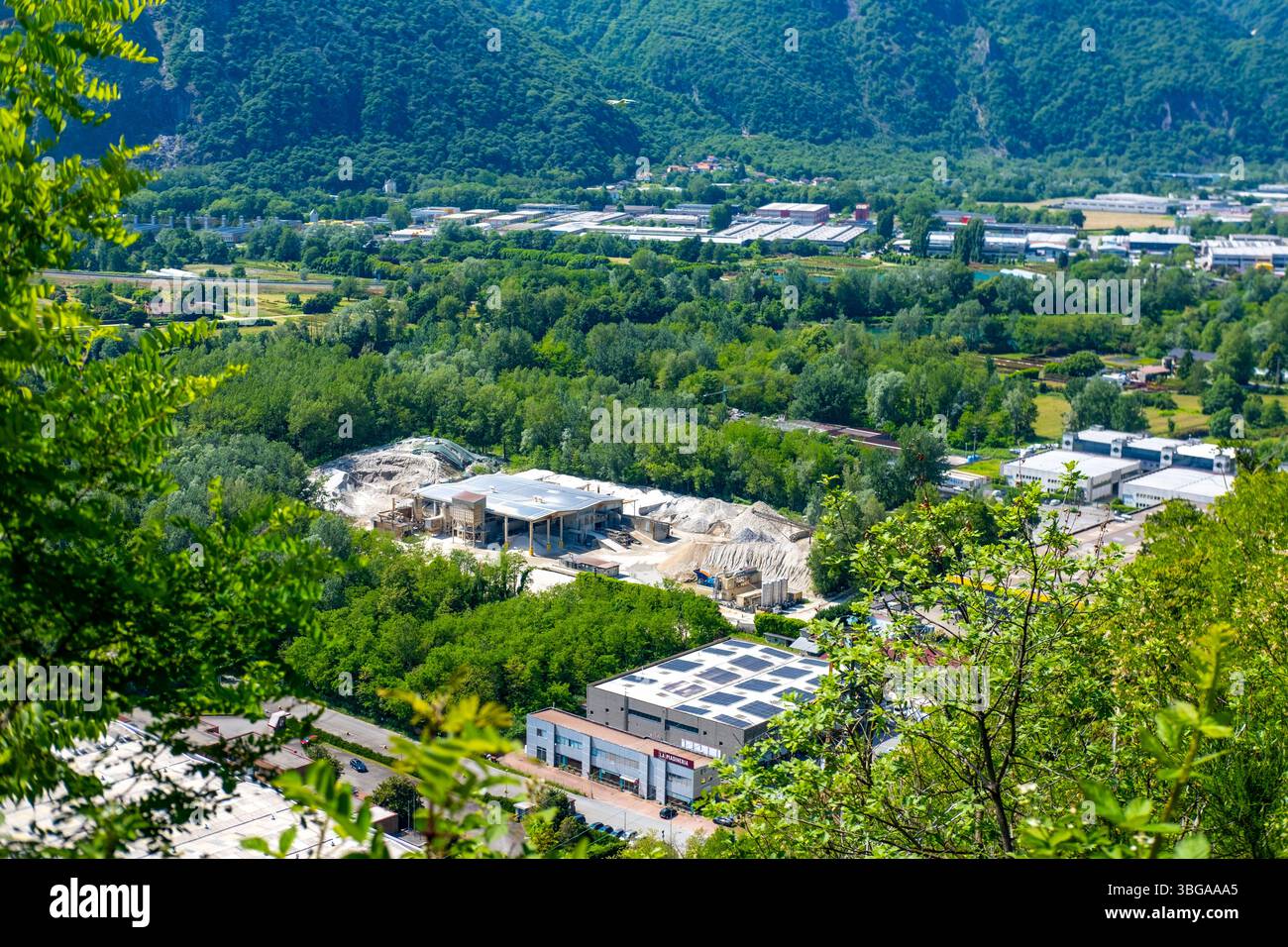 Massive rock walls and heavy machinery in active stone mining site ...