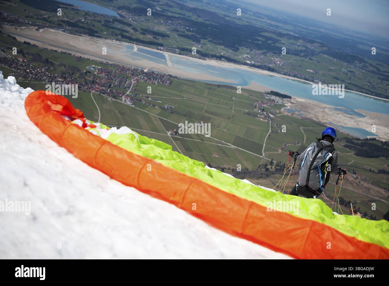 Rear view of a paraglider in take-off position at the launch site for ...