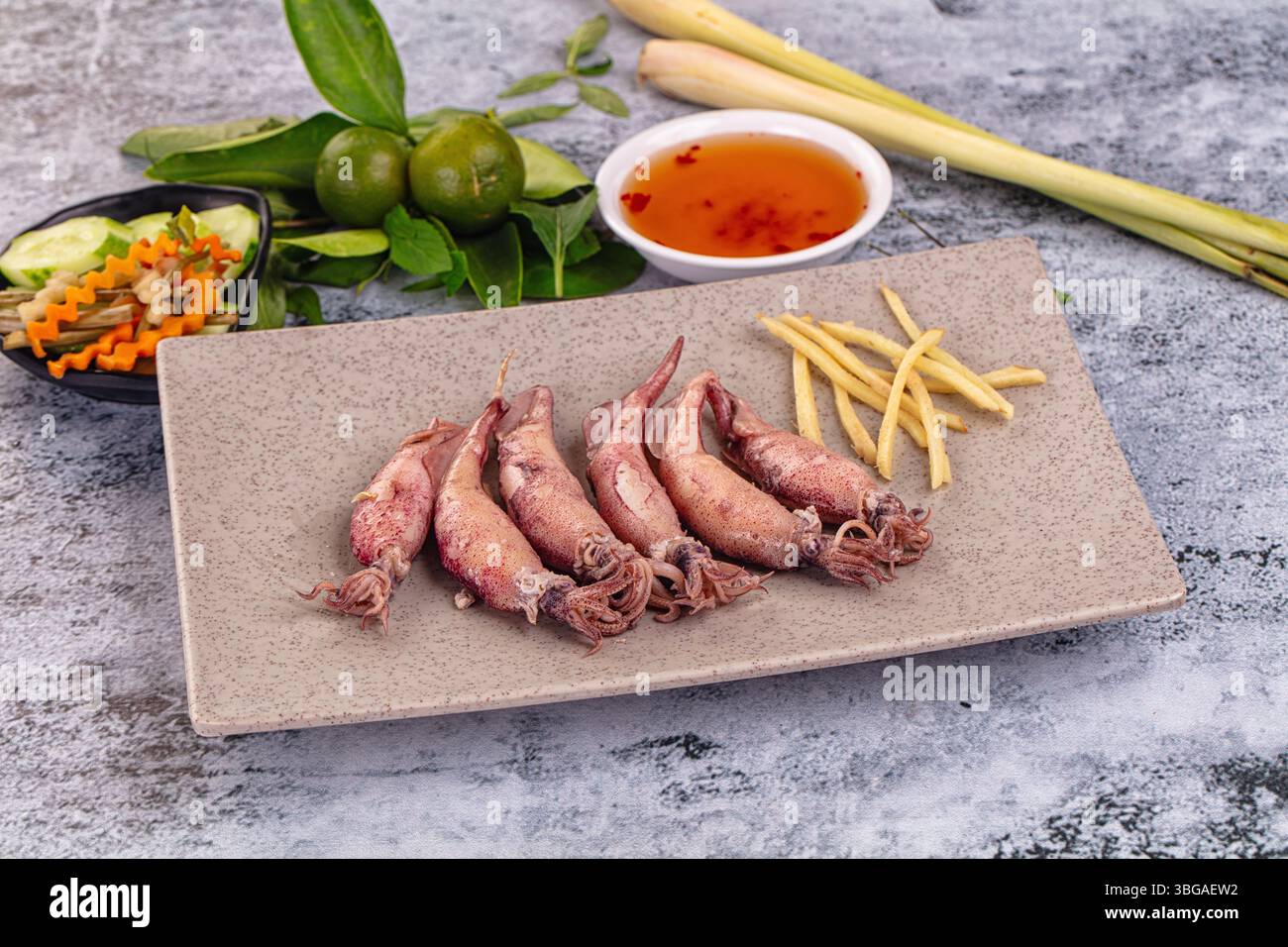 Boiled wild mini calamari snack with ginger Stock Photo - Alamy