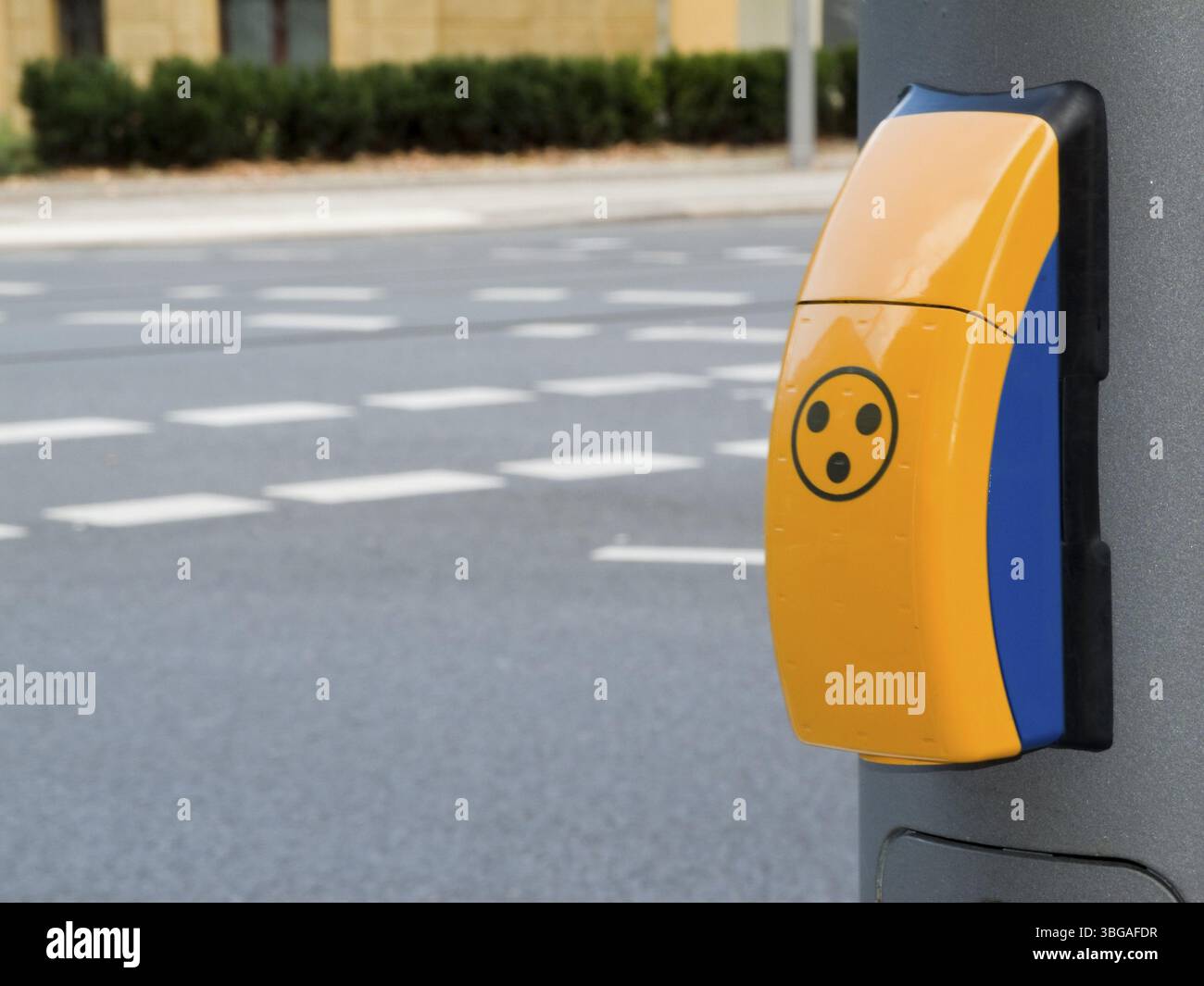 Yellow push-button switch with blind sign at a road junction in ...