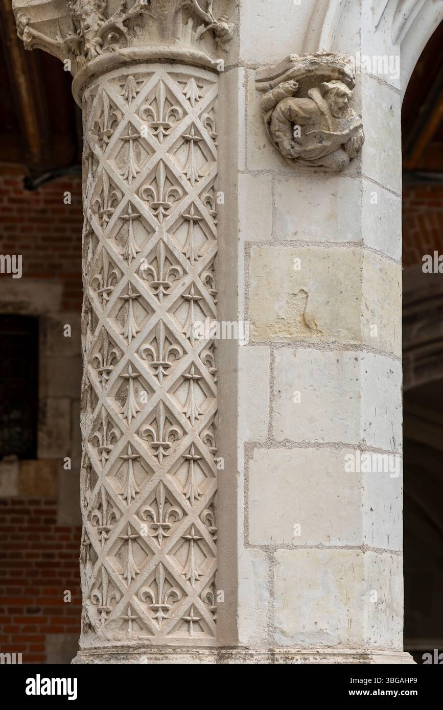 Ornate stone pillar displays intricate fleur-de-lis carvings and Gothic ...