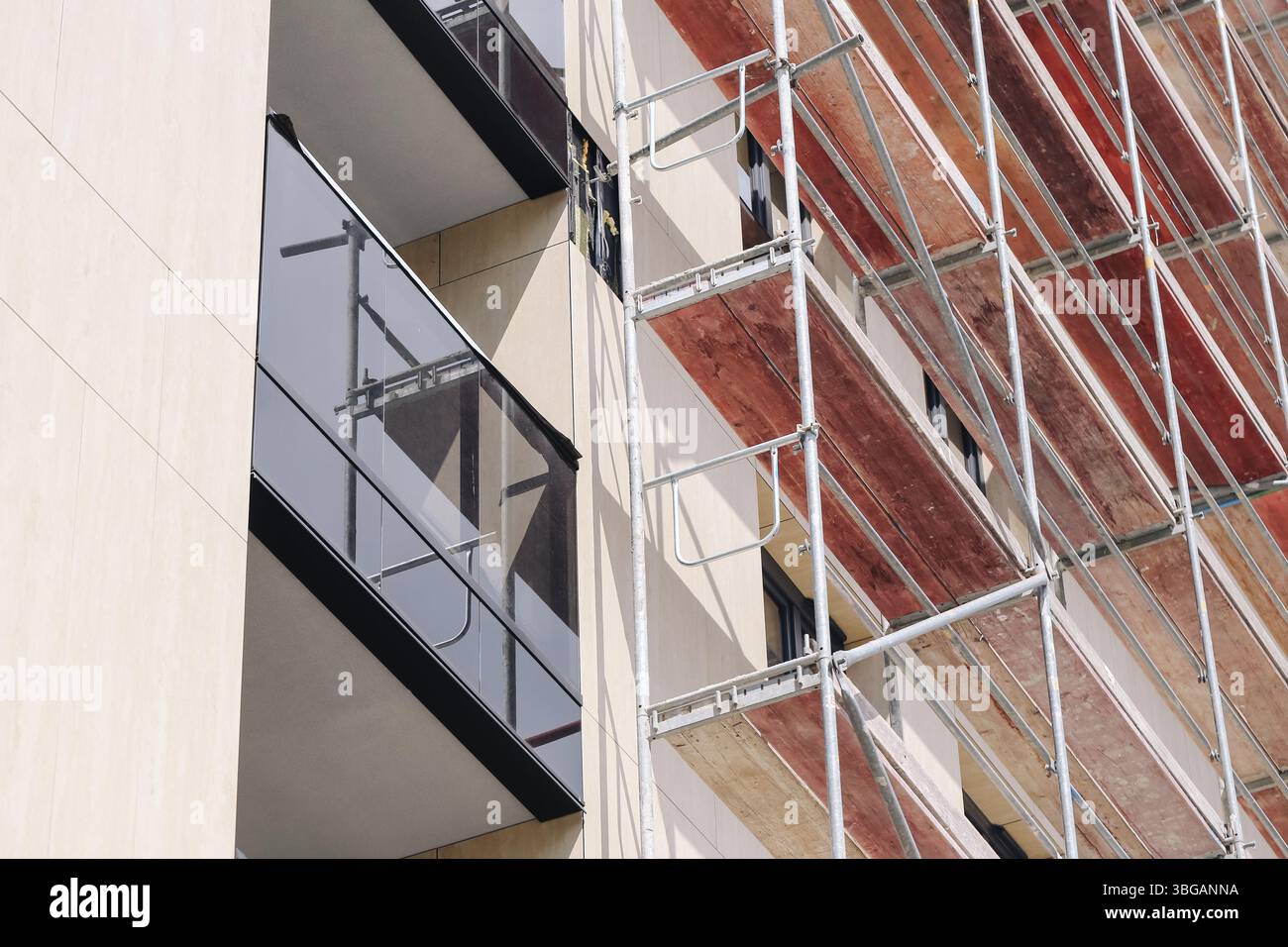 Scaffolding on modern facade. Construction site with metal supports ...