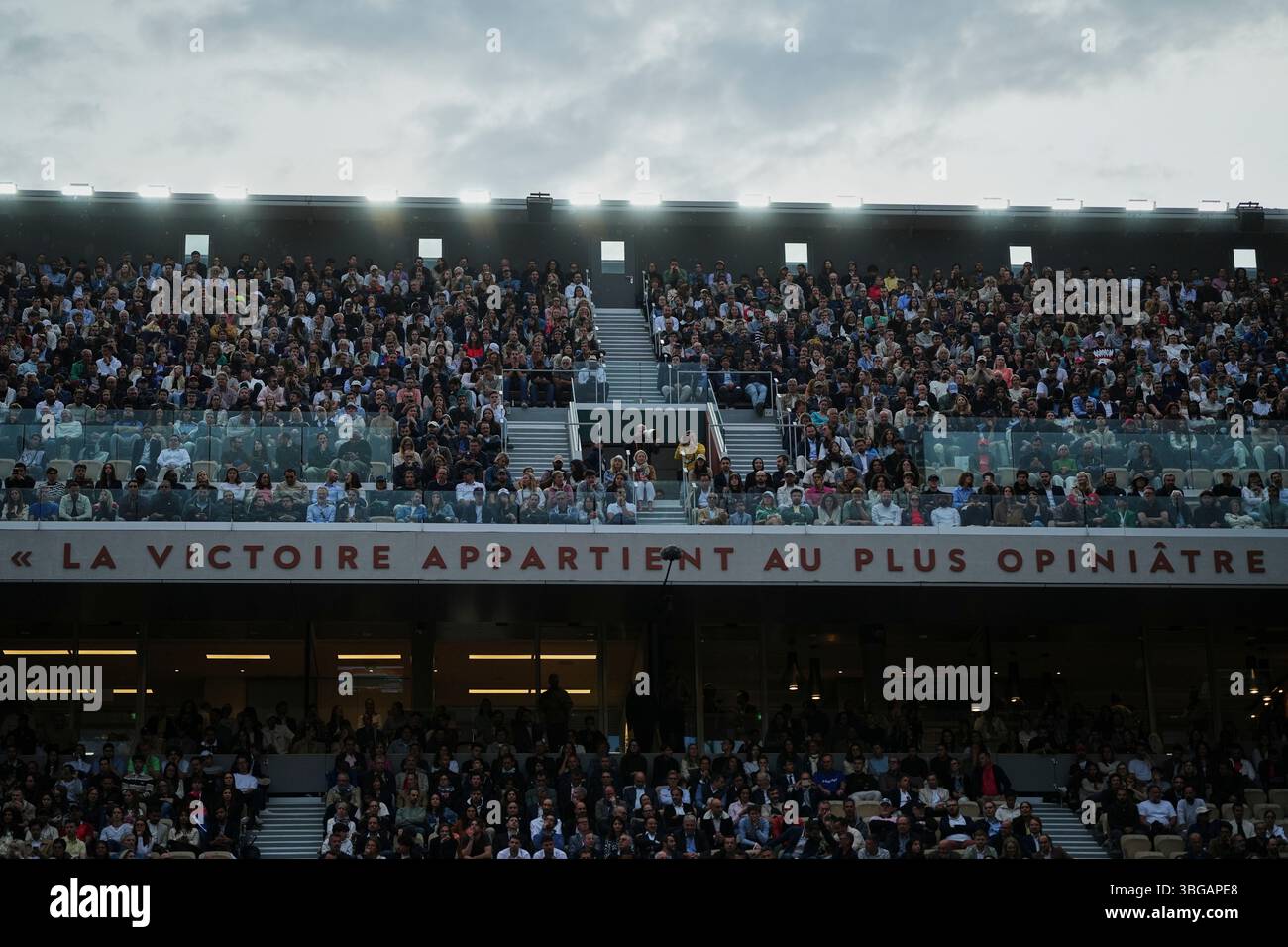 Spectators watch the quarterfinal match of the French Tennis Open ...