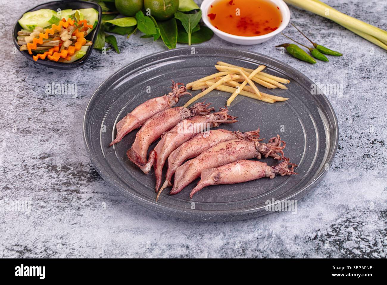 Boiled wild mini calamari snack with ginger Stock Photo - Alamy