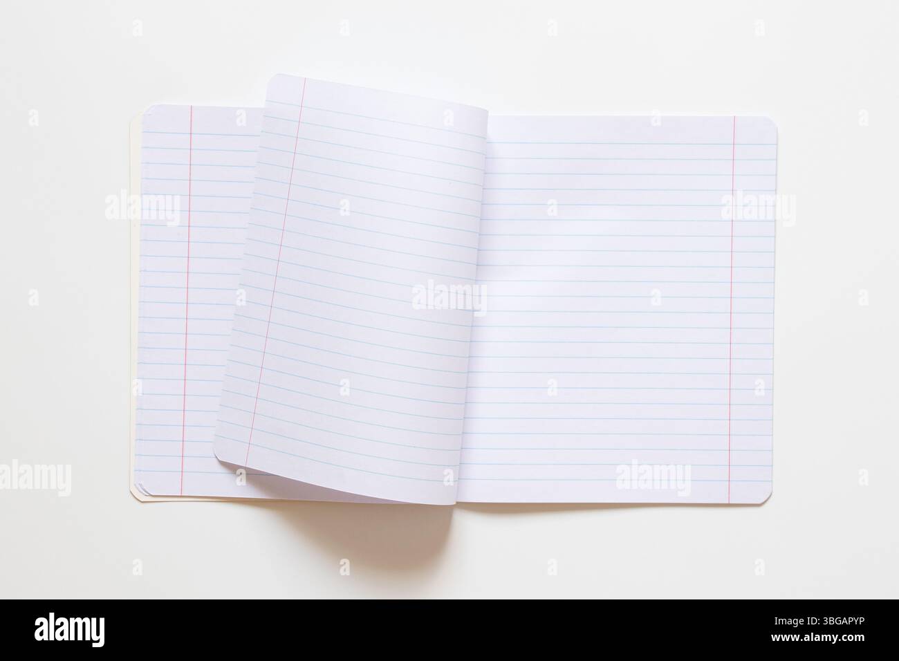 One notebook in a line, fastened with staples on a white background ...