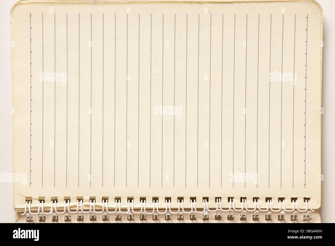 Open spiral notebook with blank lined sheets as a background for notes ...