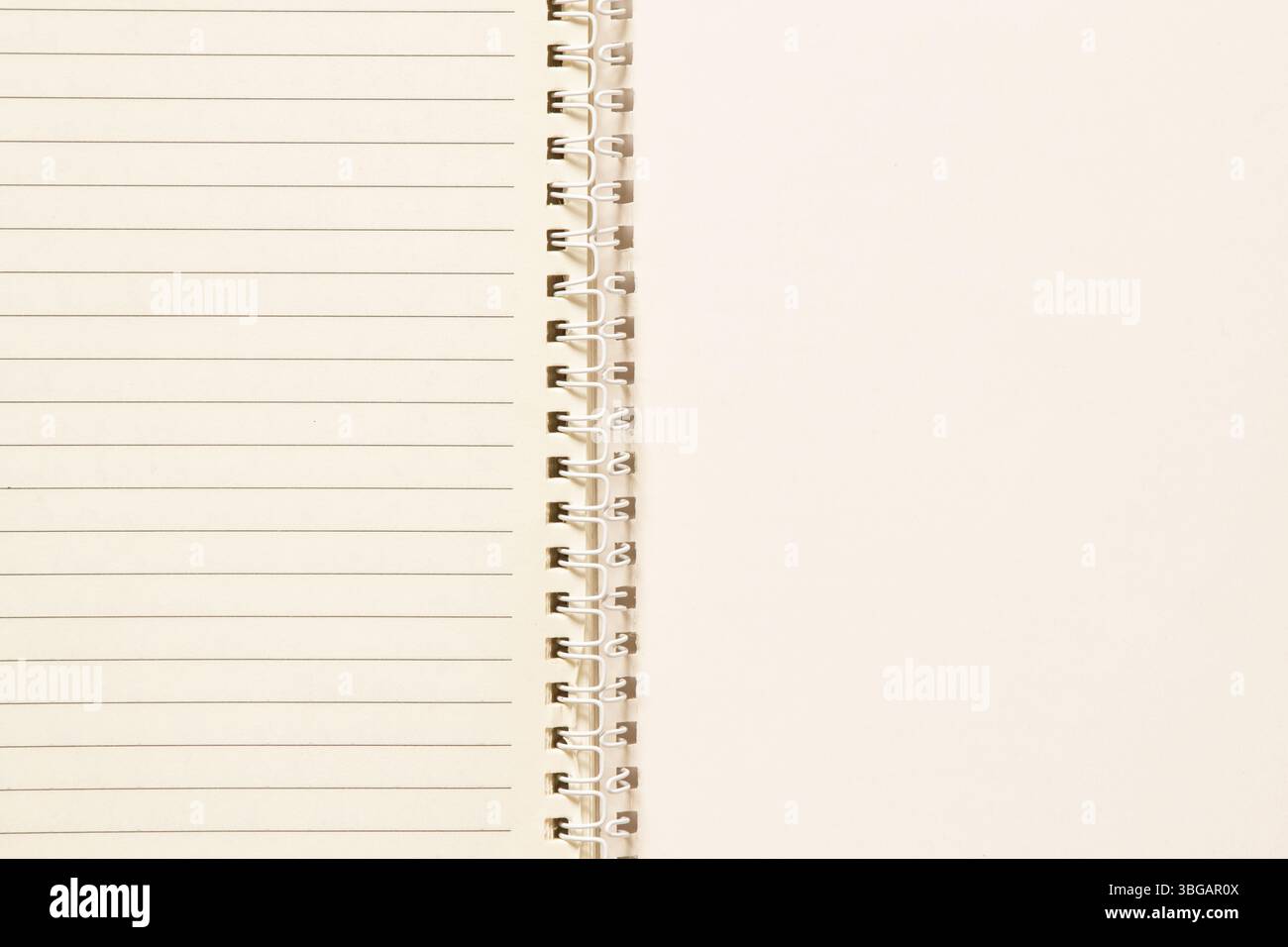Open spiral notebook with blank lined sheets as a background for notes ...