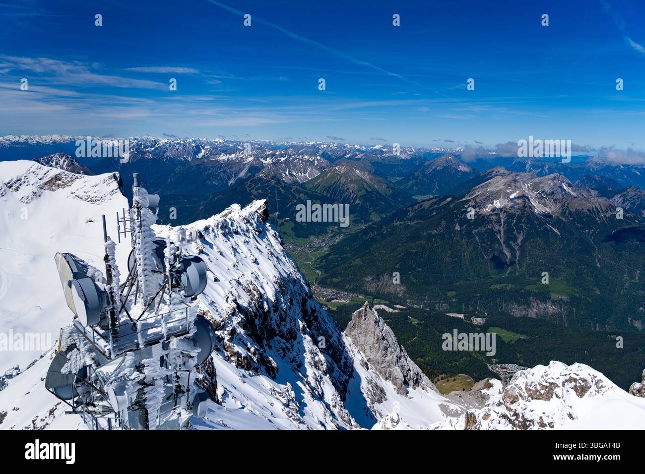 Snow-covered summit of Zugspitze with communication tower and panoramic ...