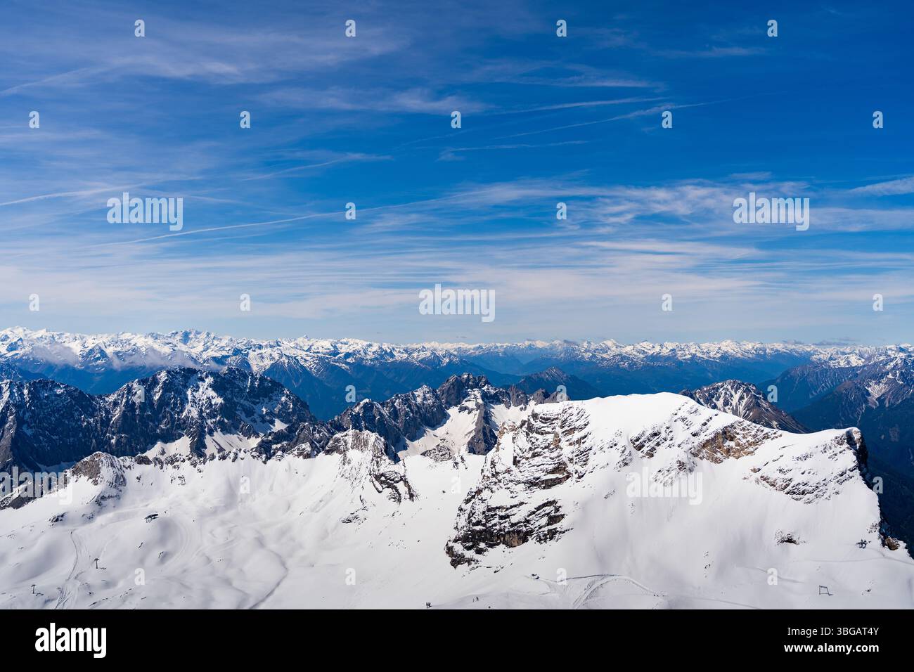 Snow-covered Zugspitze summit with panoramic view of the Alps Stock ...