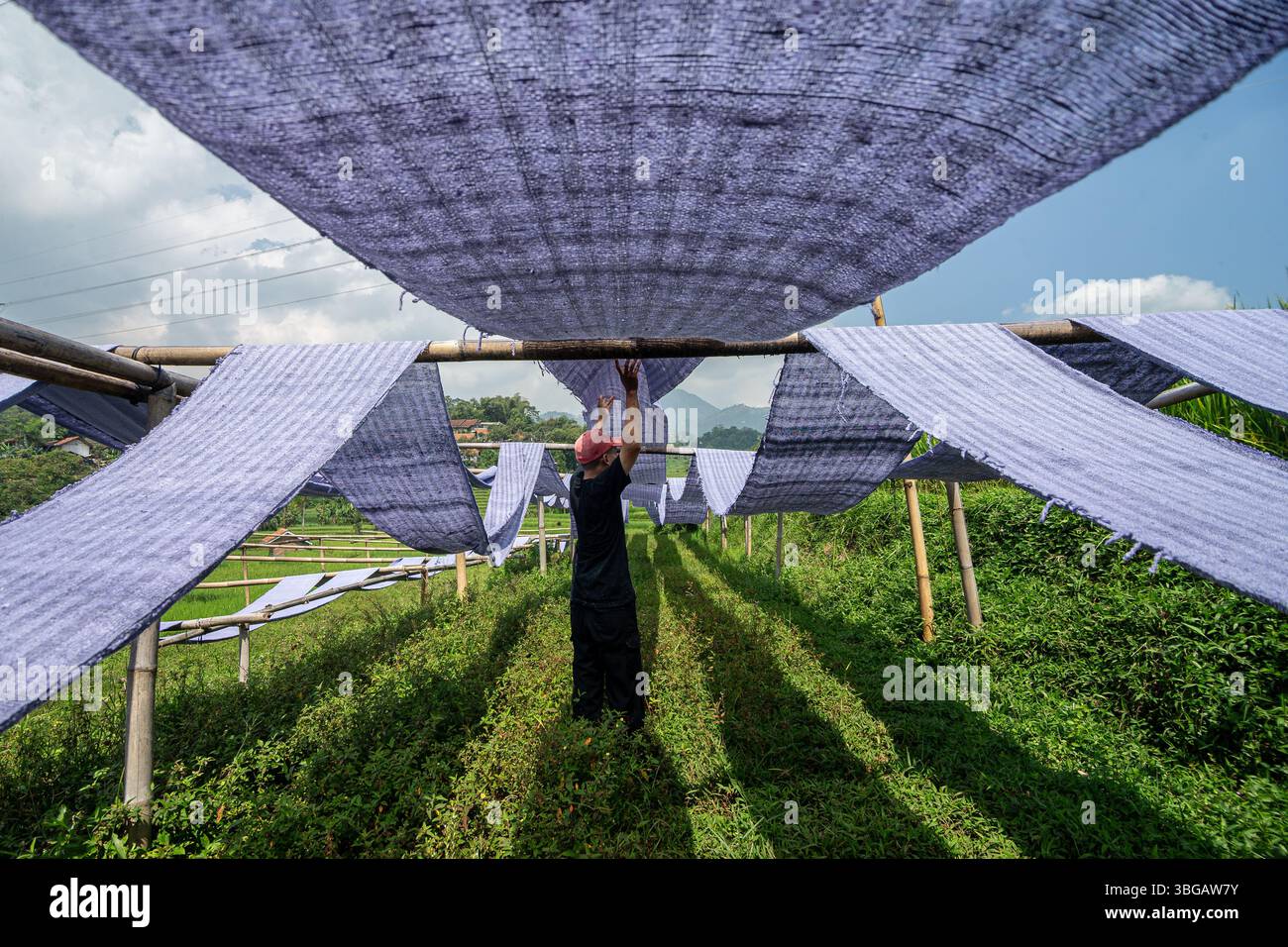 Craftsmen dry cloth to be made into mops at the traditional industrial ...