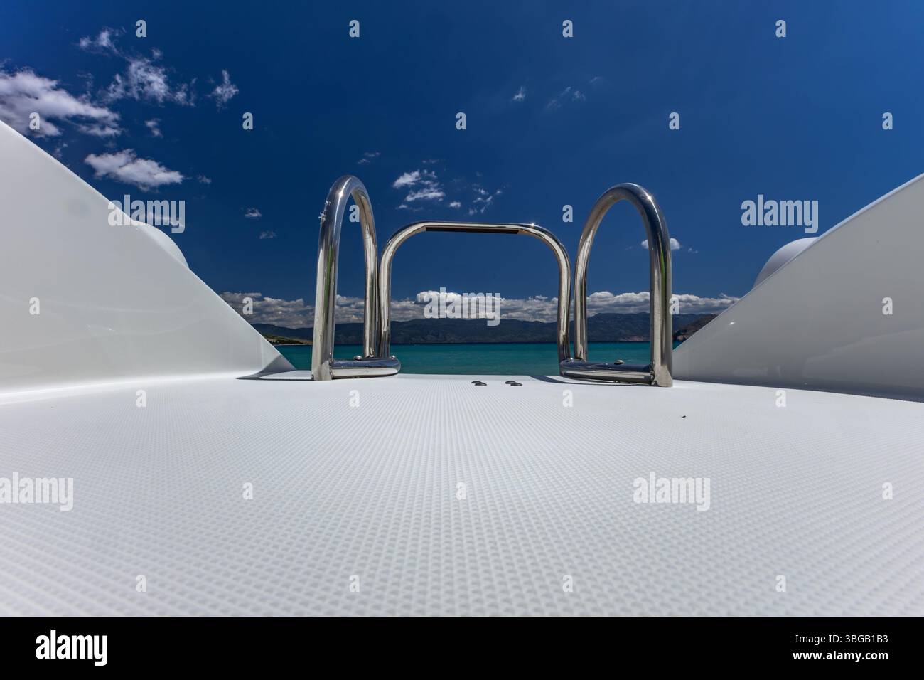 White deck of the boat with railing and access to the sea, sailing on ...