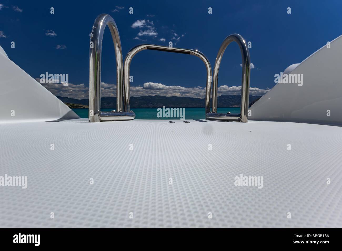White deck of the boat with railing and access to the sea, sailing on ...