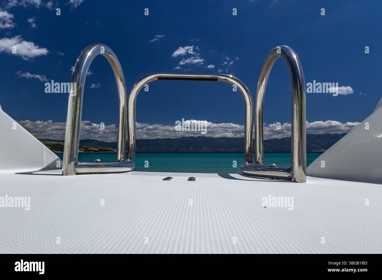 White deck of the boat with railing and access to the sea, sailing on ...