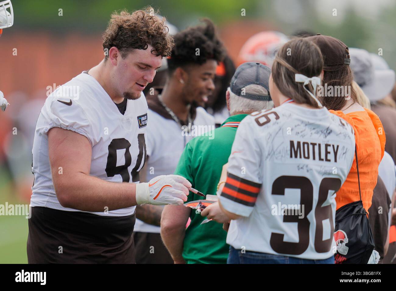 Cleveland Browns defensive tackle Mason Graham, left, signs autographs ...