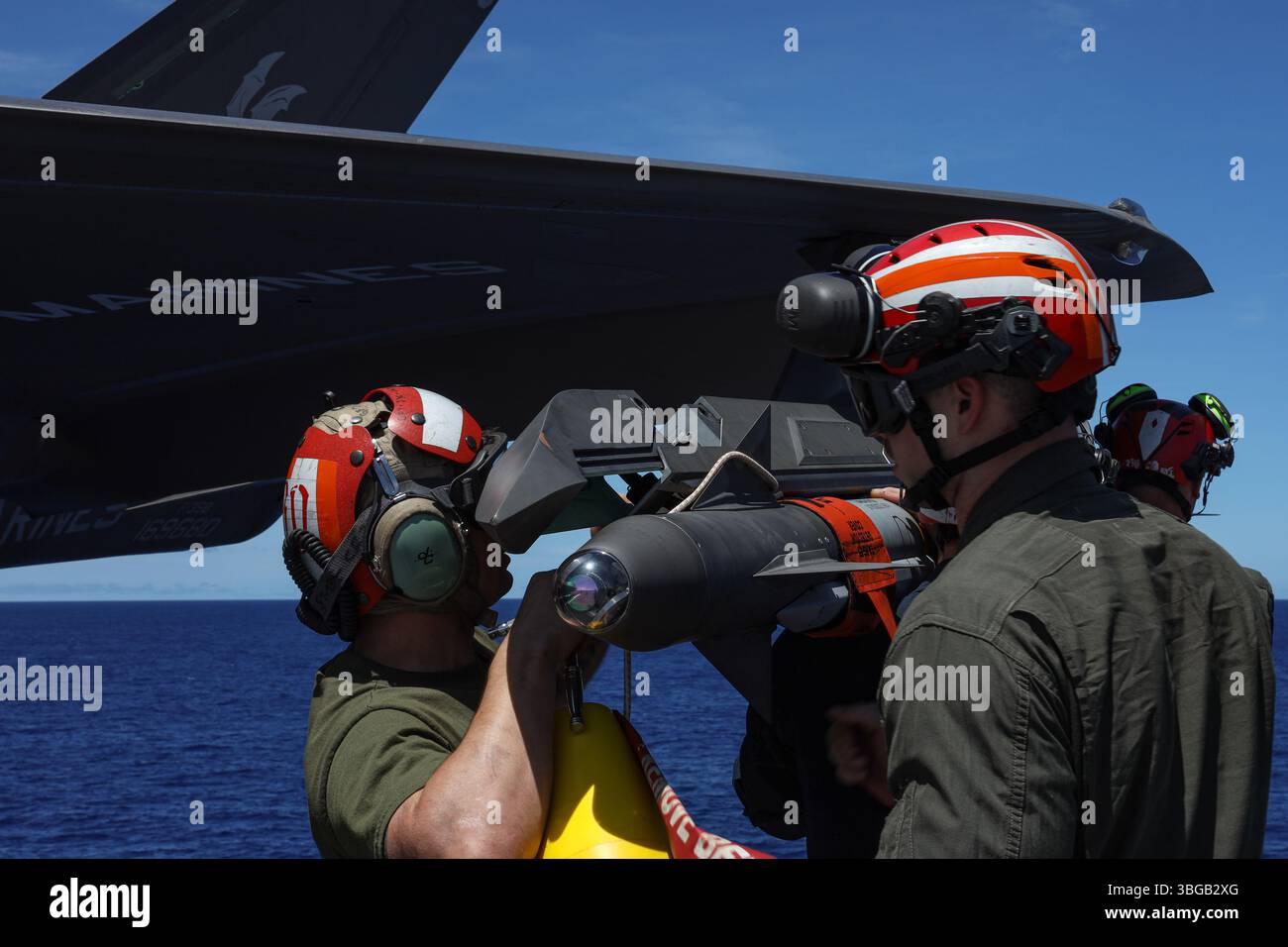 U.S. Marines load Air Intercept Missile-9X ordinance onto an F-35B ...