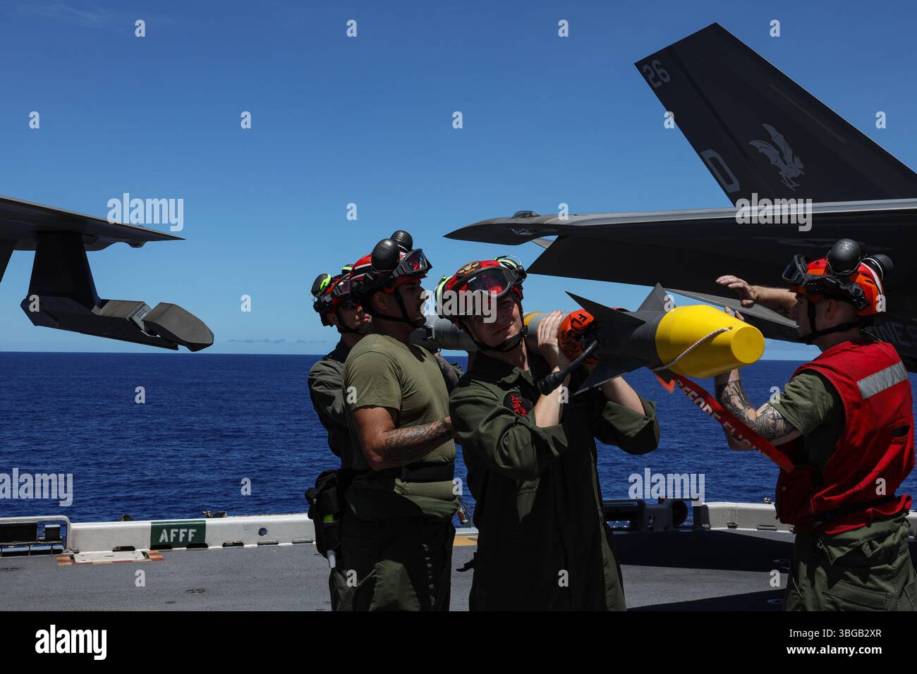 U.S. Marines load Air Intercept Missile-9X ordinance onto an F-35B Lightning II aircraft ...