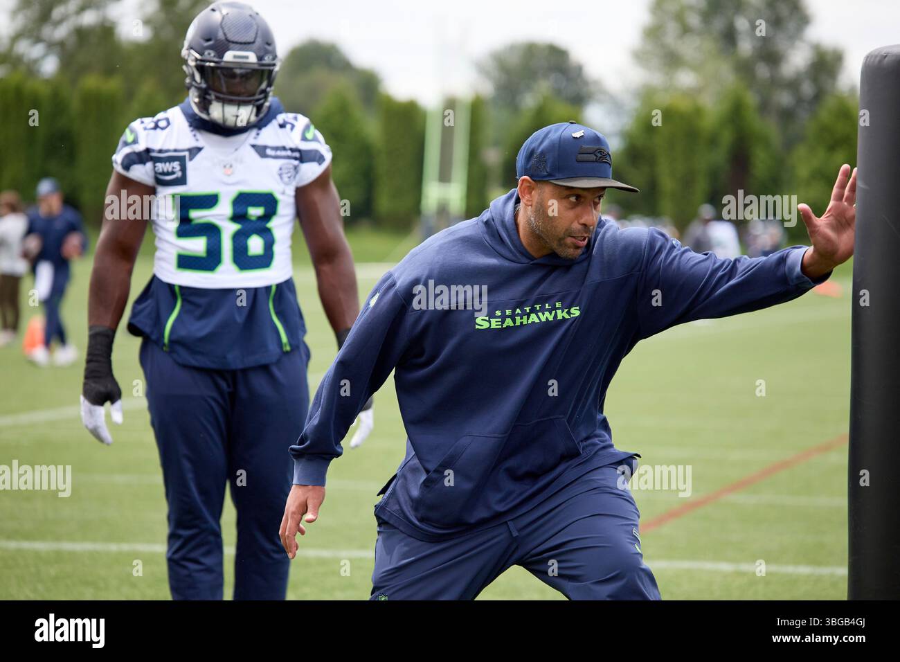Seattle Seahawks defensive coordinator Aden Durde demonstrates a drill ...