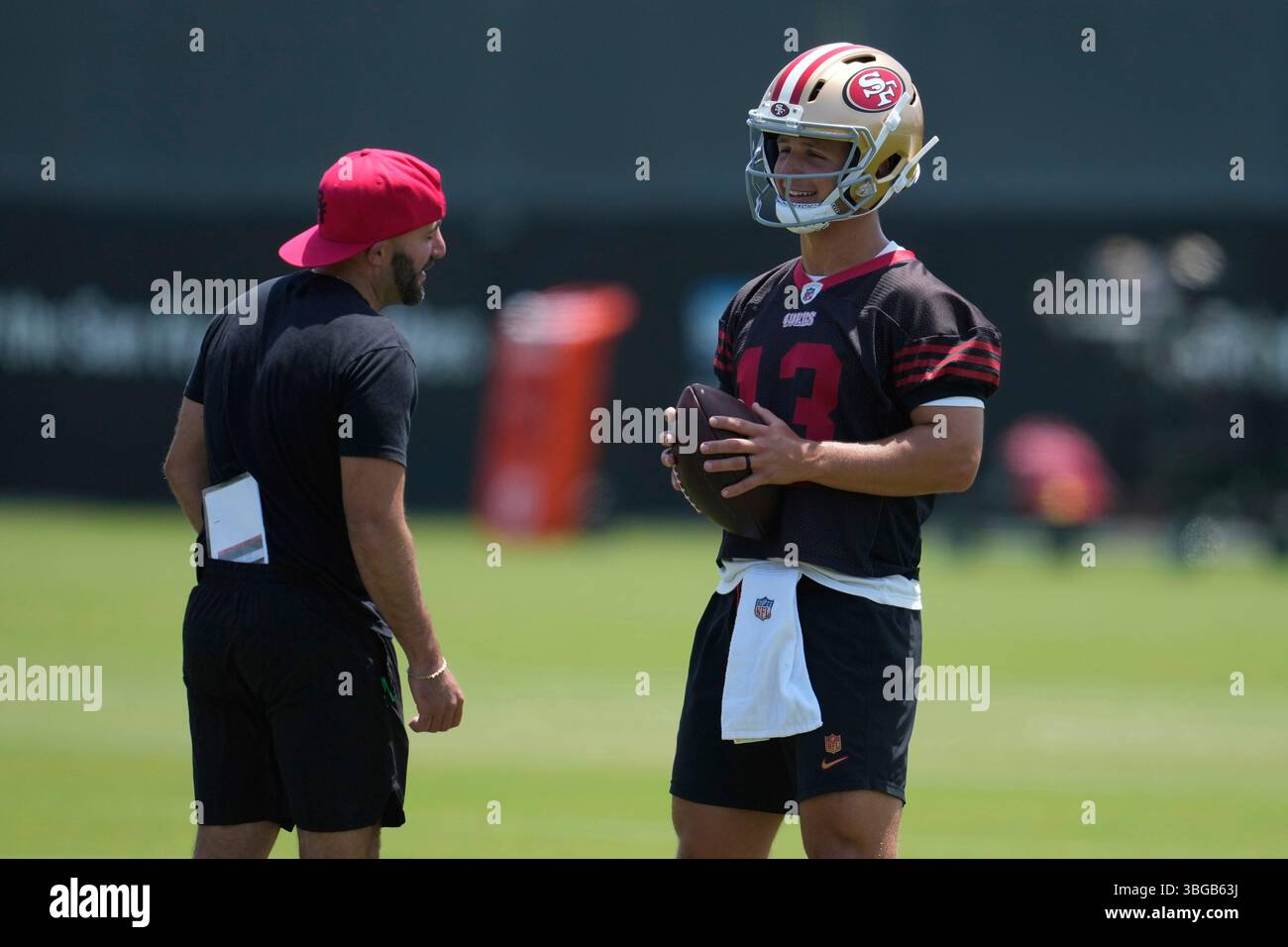 San Francisco 49ers quarterbacks coach Mick Lombardi, left, talks with ...
