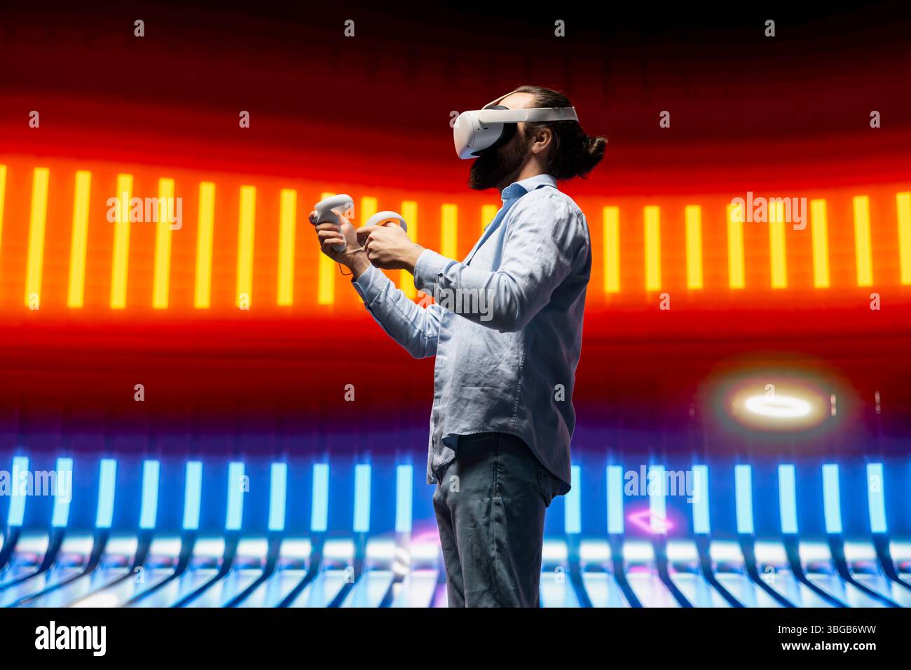 Modern man in a neon lit night scene using vr high tech glasses ...