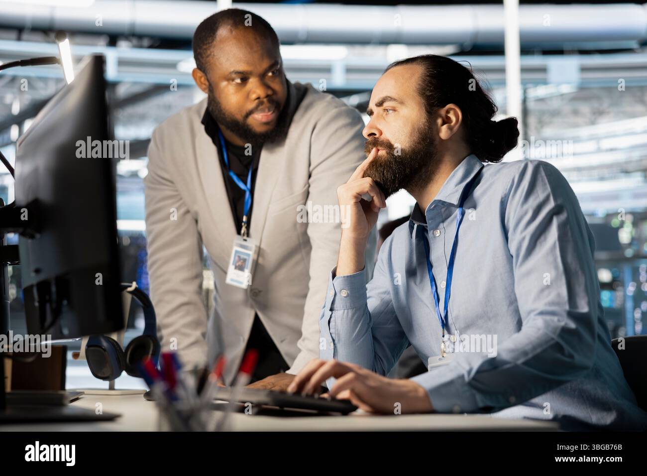 Data center manager supervising work done by employee verifying neural network parameters ...
