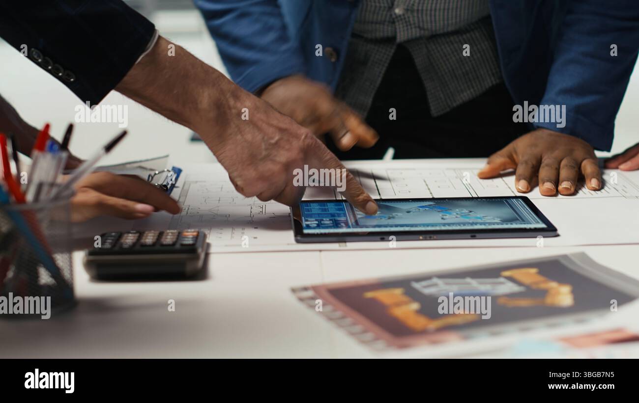 Factory experts designing assembly facility production lines in tablet ...