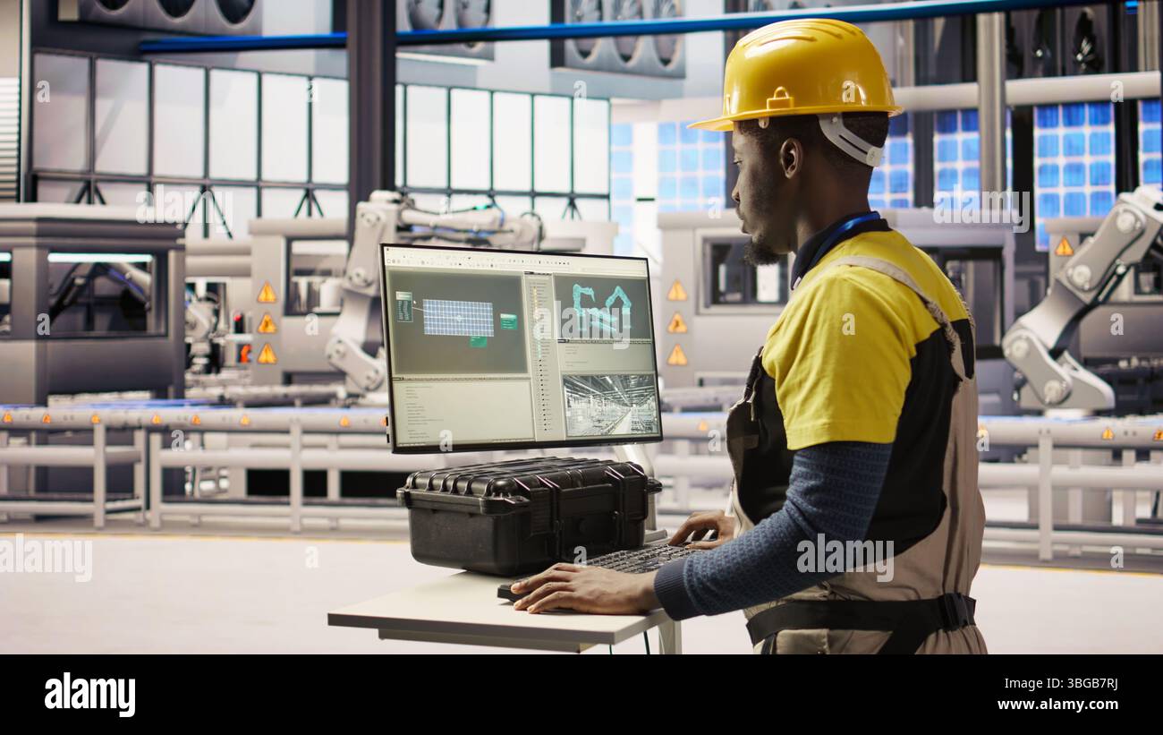 Engineer overseeing solar panel production lines equipment using PC software. Worker maintaining ...