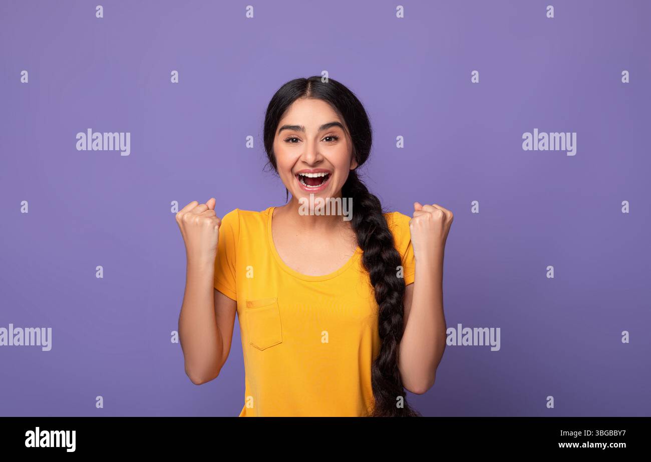 Yes. Portrait of emotional indian woman screaming with raised fists ...